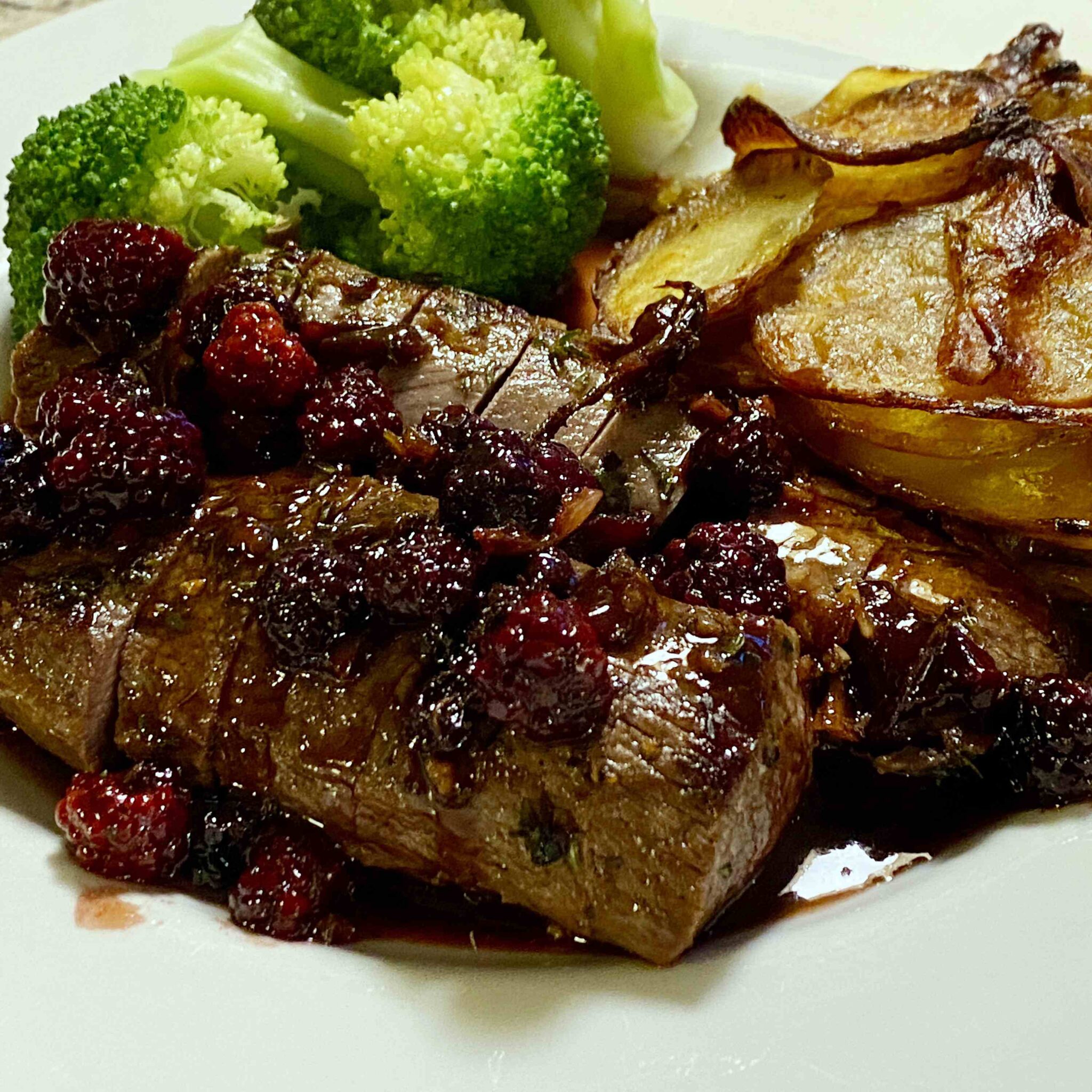 Loin of muntjac with blackberry sauce, boulangère potatoes and steamed ...